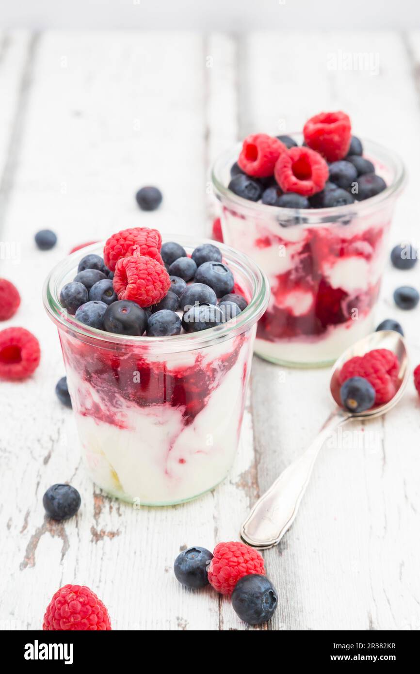 Greek yoghurt with fruit jelly and fresh raspberries and blueberries ...