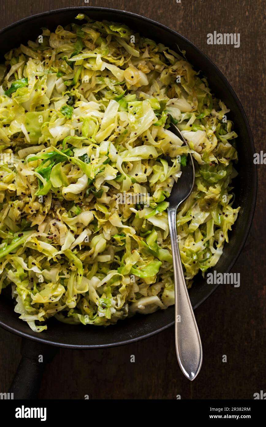 Fried spring cabbage in a cast iron pan Stock Photo - Alamy