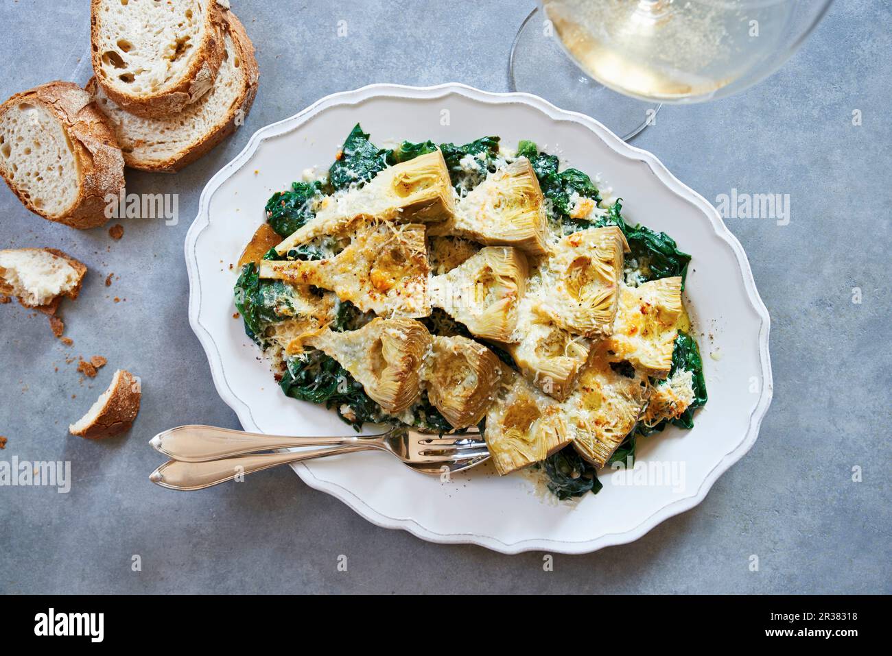 Gratinated artichokes with spinach Stock Photo - Alamy