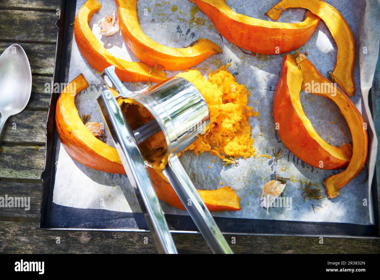 Oven-roasted pumpkin, partially mashed, on a baking tray Stock Photo ...