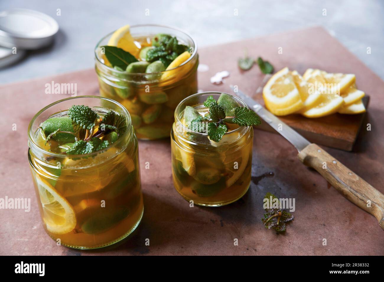 Pickled green almonds with lemons Stock Photo - Alamy