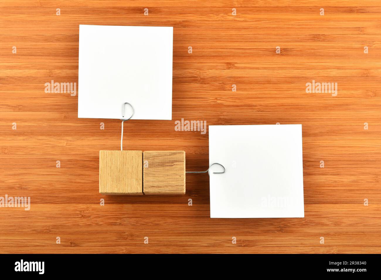 Two paper notes with wooden holders different directions on wood Stock ...