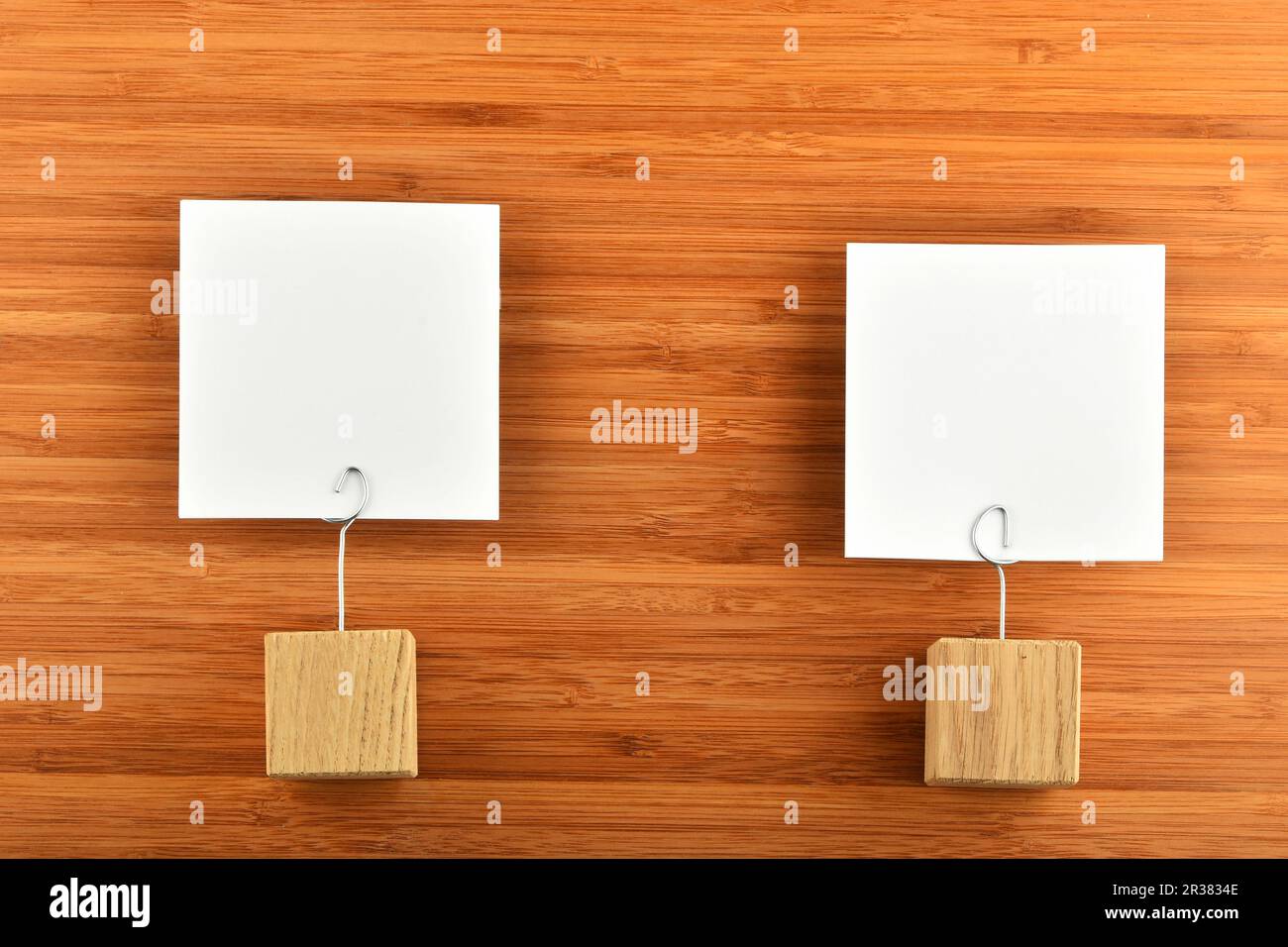 Two paper notes with wooden holders on wooden background Stock Photo ...