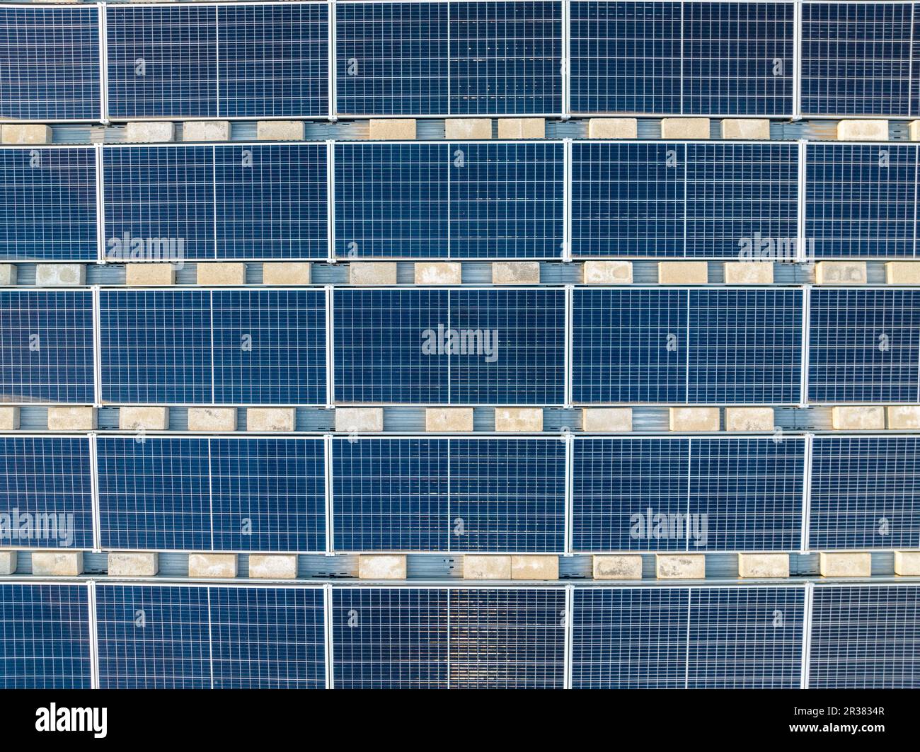 Aerial photo solar panels install on a flat commercial, industrial roof ...