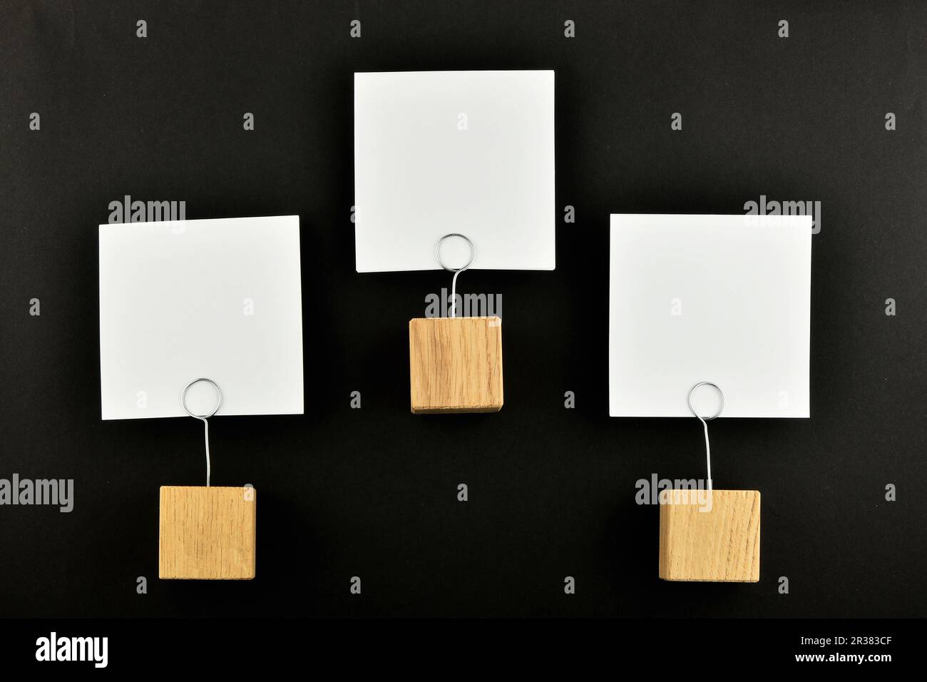 Hierarchy, Three paper notes with holders black background for ...