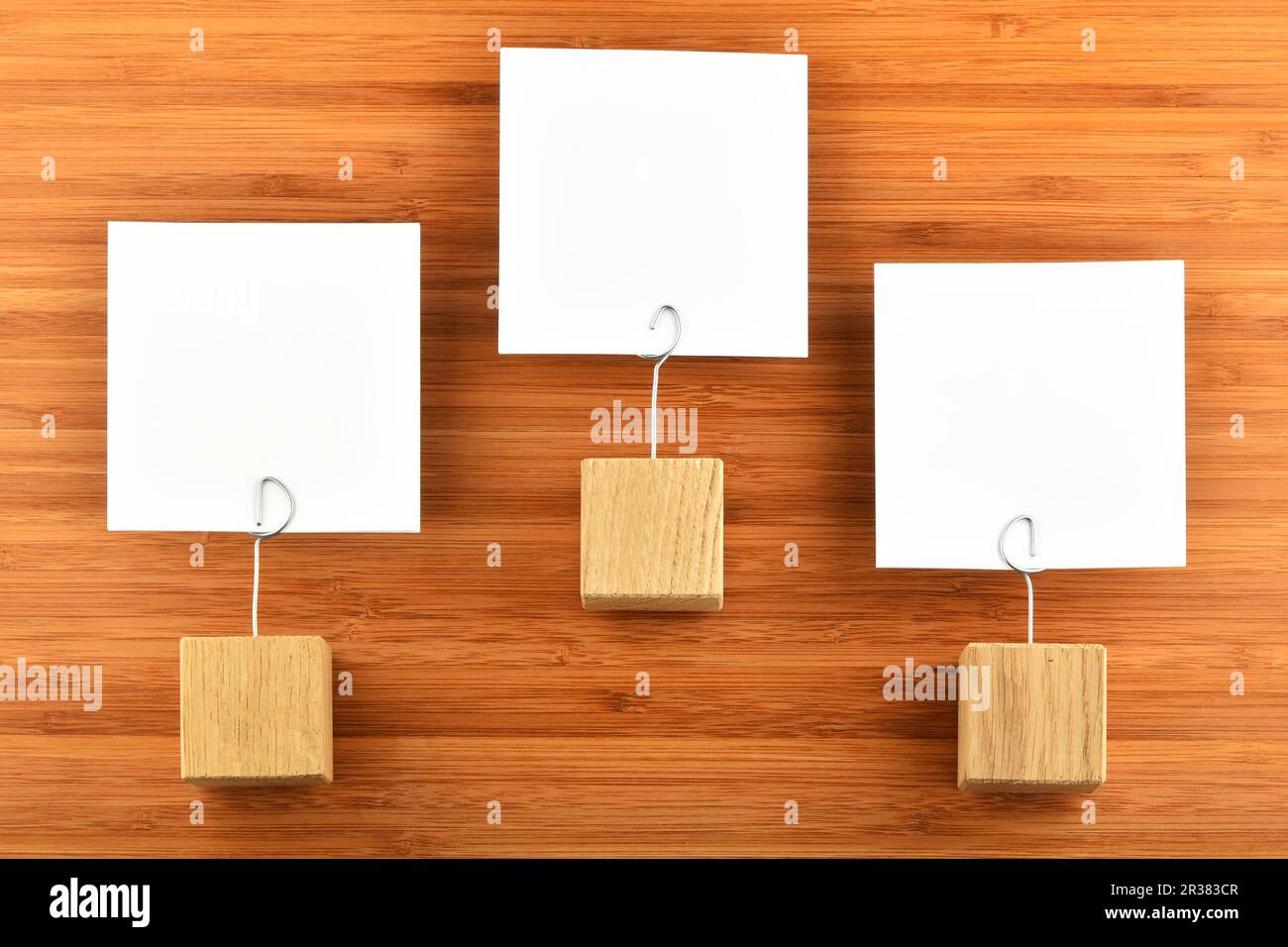 Three paper notes with holders isolated bamboo wooden background Stock ...