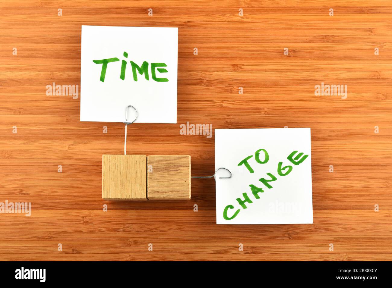 Time to change, two paper notes with holders on wood Stock Photo - Alamy