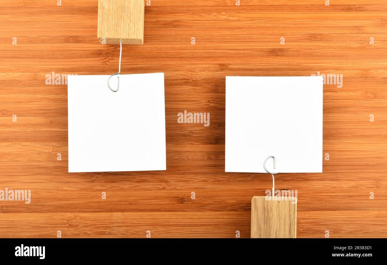 Two paper notes with holders in different directions on wood Stock ...