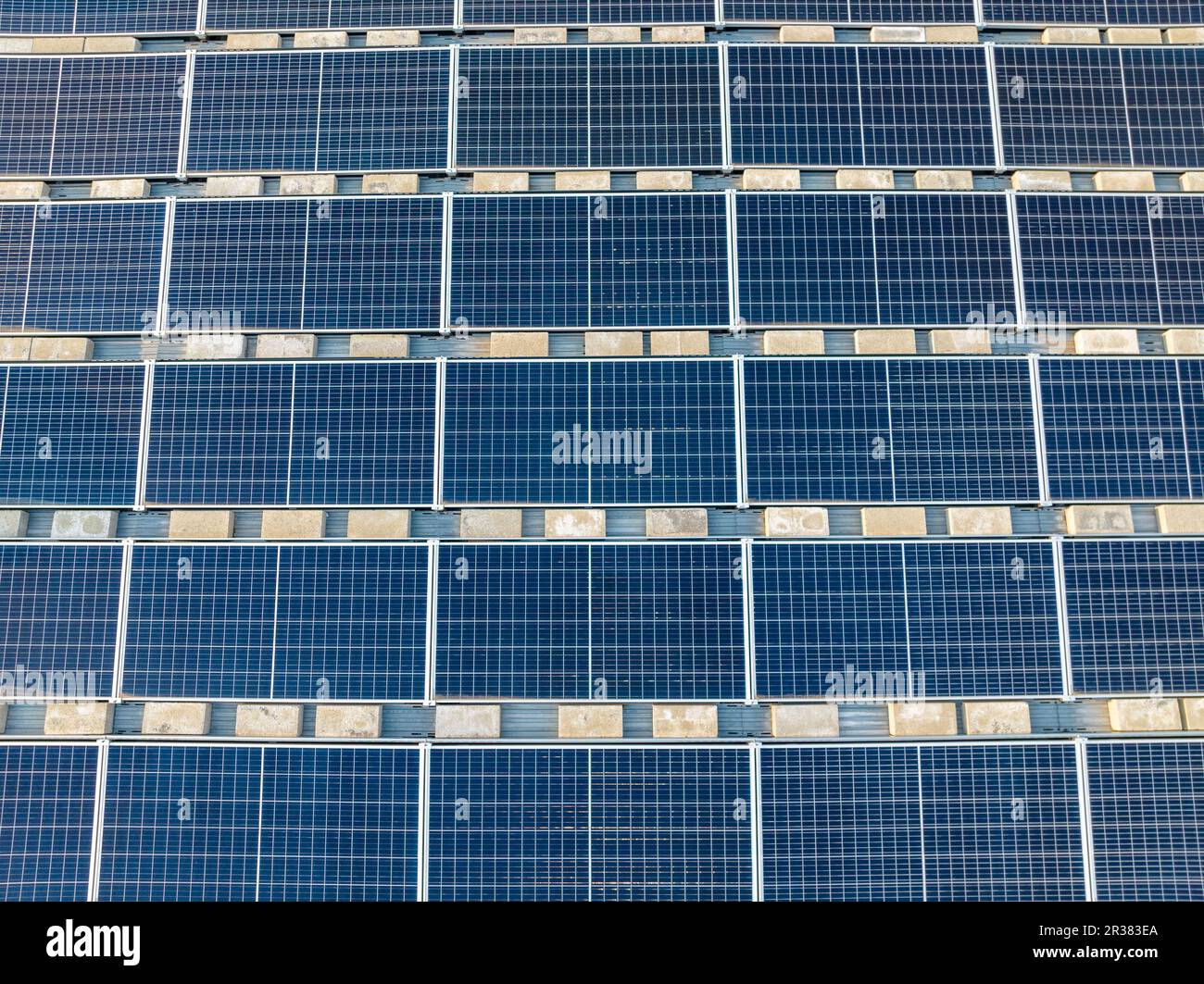 Aerial photo solar panels install on a flat commercial, industrial roof ...
