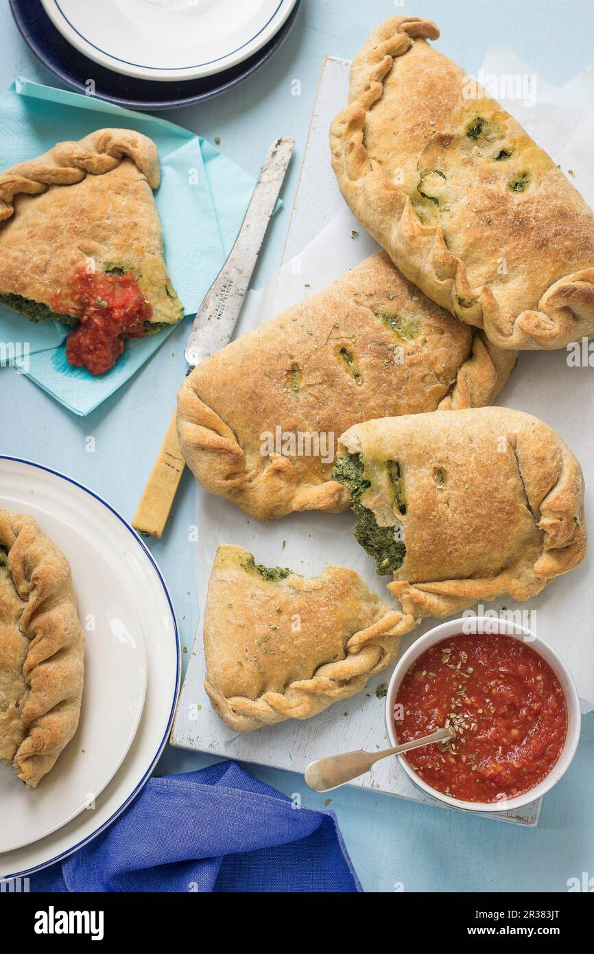 Spinach and ricotta calzone with tomato sauce Stock Photo - Alamy