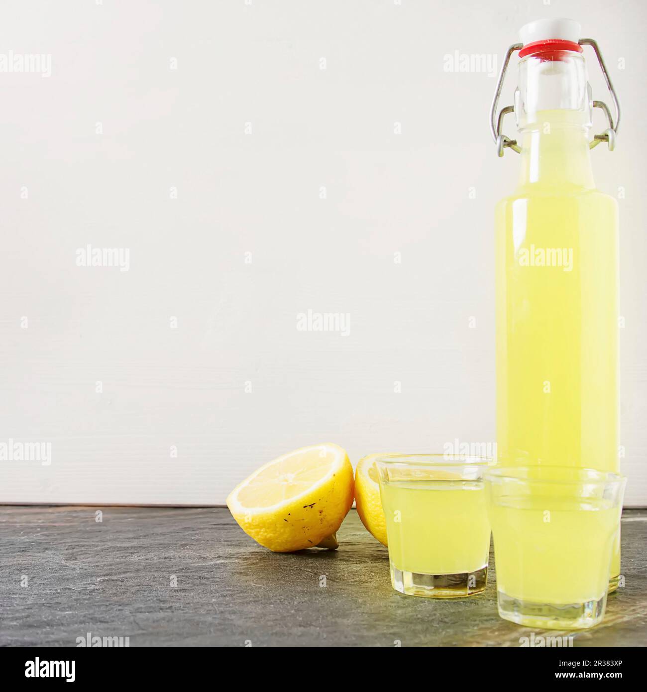 Limoncello in a bottle and glasses Stock Photo - Alamy