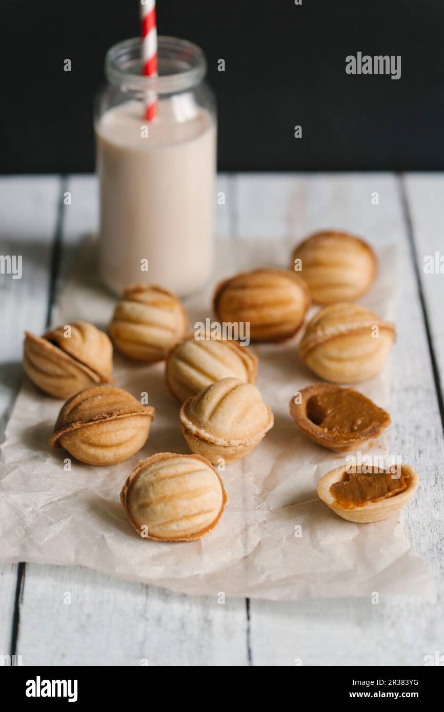 Cream-filled nut biscuits and a milkshake in a bottle Stock Photo - Alamy
