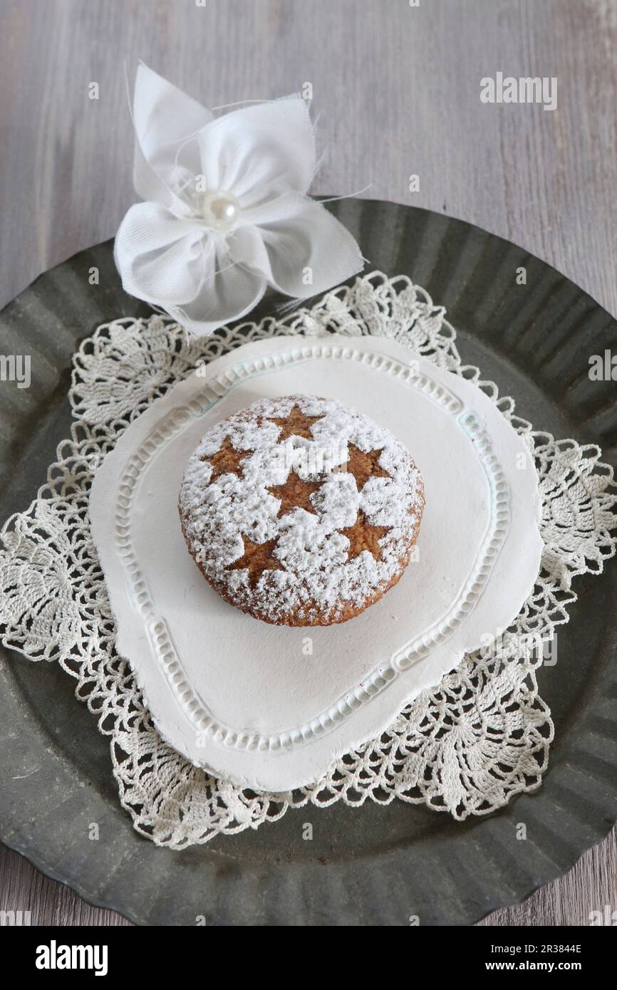 Homemade gingerbread with icing sugar dusted in a star pattern, on a ...