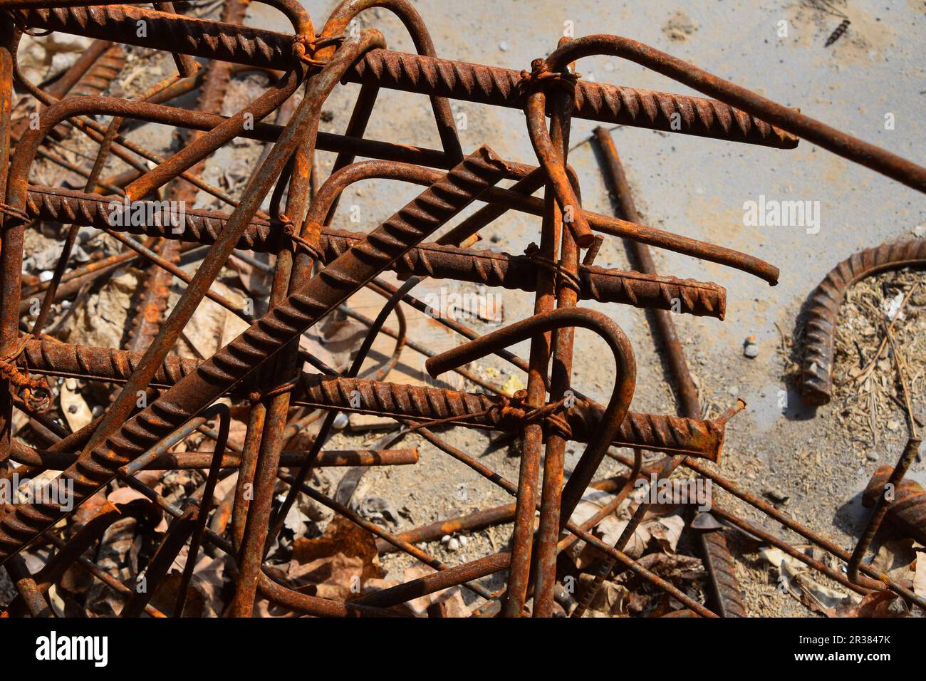 Rusty corroded stained metal pieces: wire, fitting, armature on a dirty ...