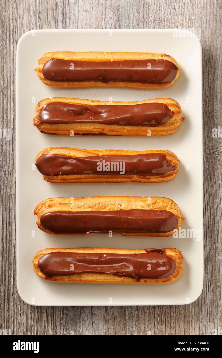 Chocolate eclairs on a serving plate (seen from above Stock Photo - Alamy