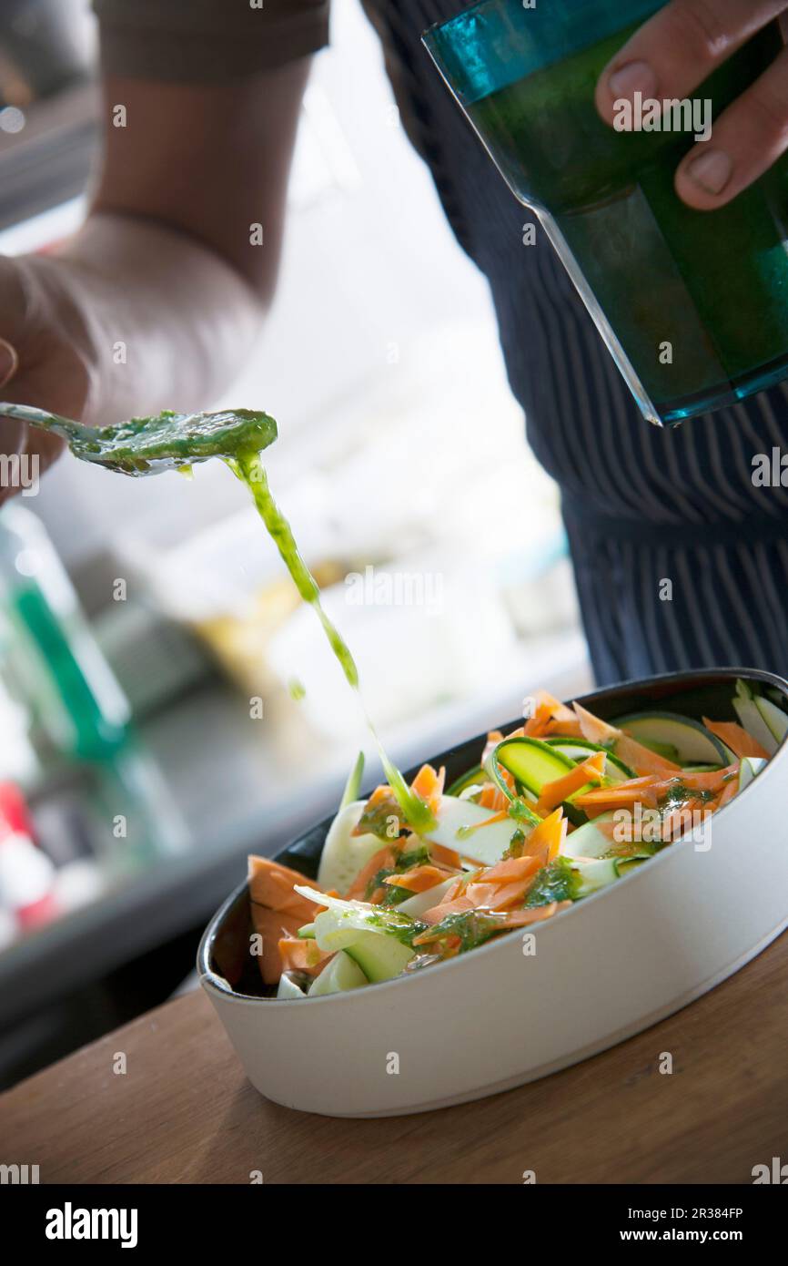 A vegetable salad is drizzled with dressing Stock Photo - Alamy