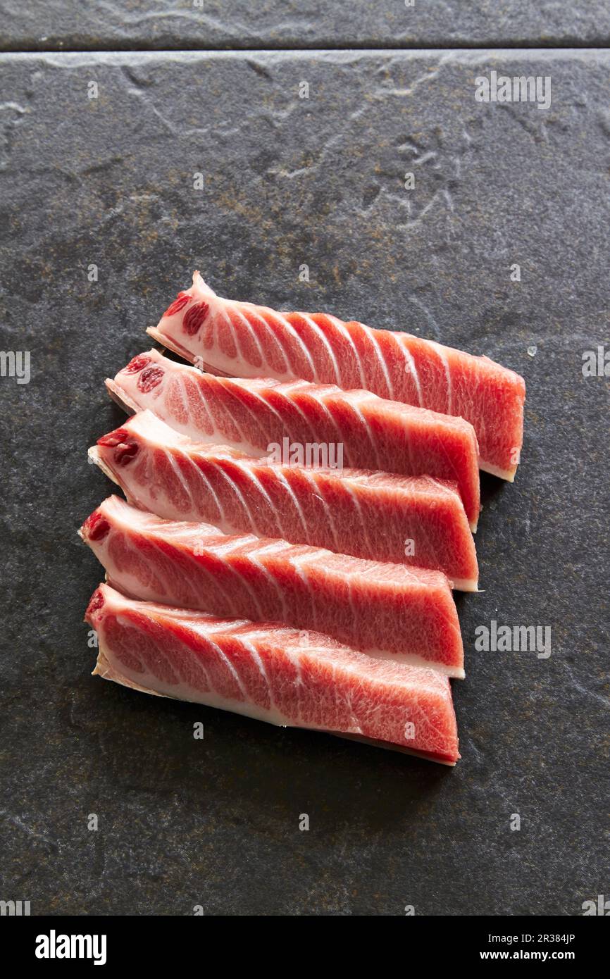 Raw tuna steaks on a grey background Stock Photo - Alamy
