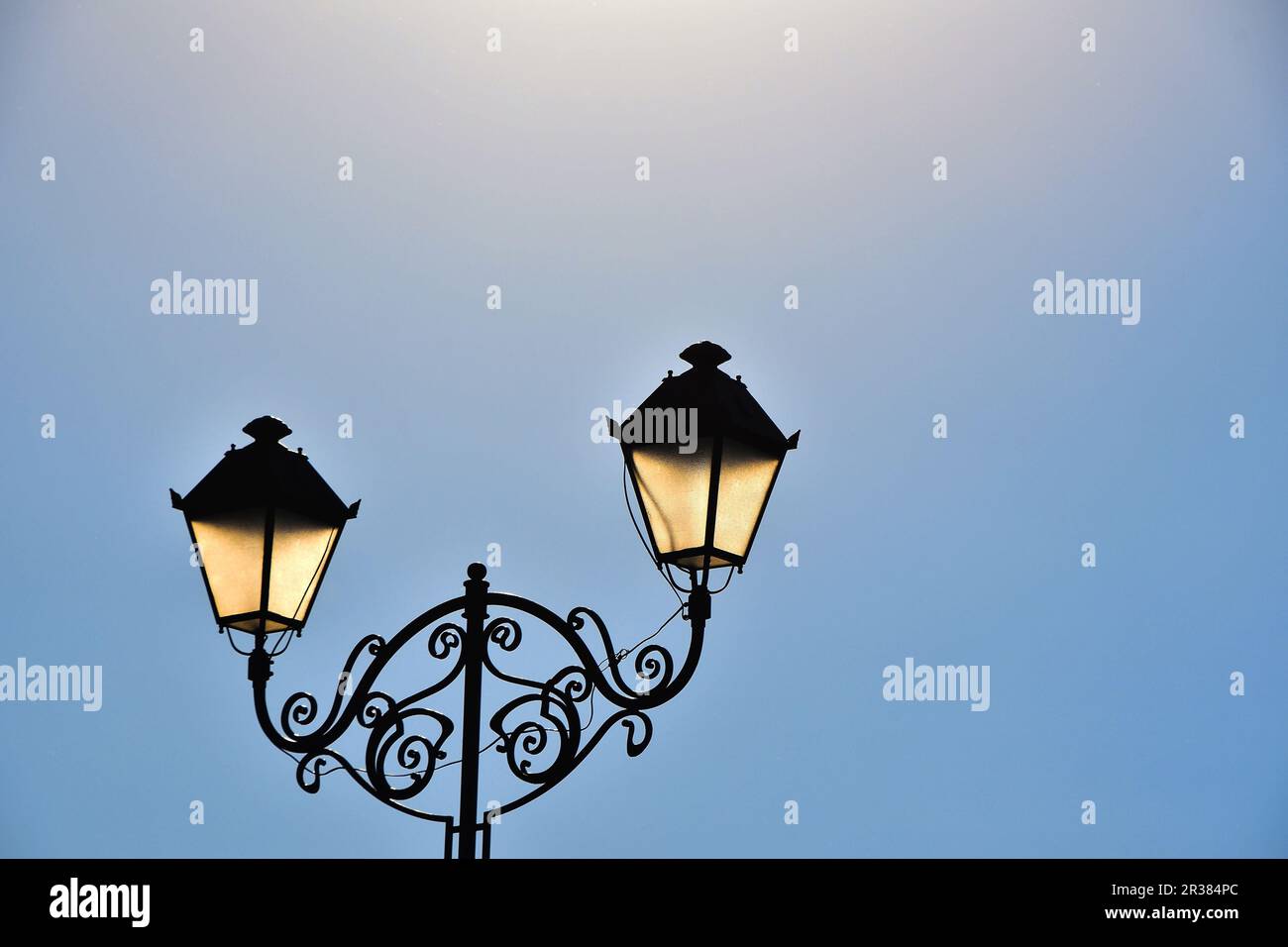 Street antique double lamp post and blue sky Stock Photo - Alamy