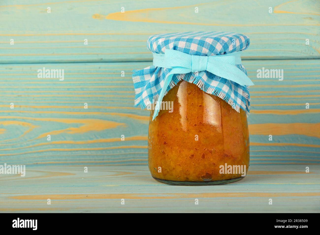 One jar of quince jam at blue vintage wood surface Stock Photo - Alamy