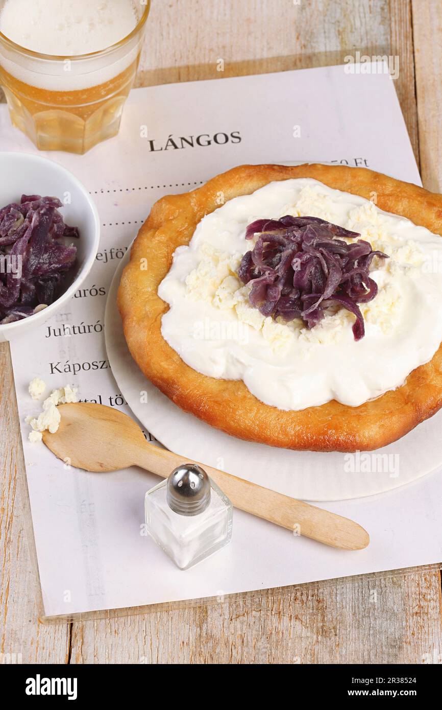 Langos (yeast flat bread, Hungary) with sour cream, feta and onion jam ...