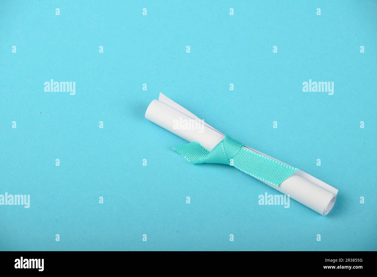 One white paper scroll message on blue background Stock Photo - Alamy