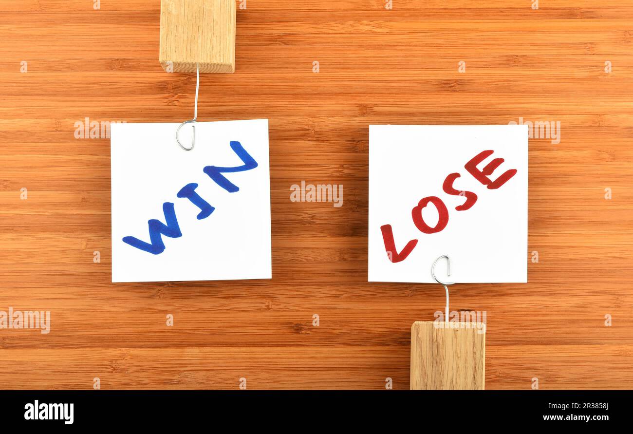 Win lose two paper notes in different directions on wood Stock Photo ...