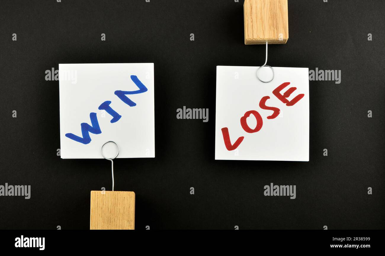Win lose, two paper notes on black background Stock Photo - Alamy