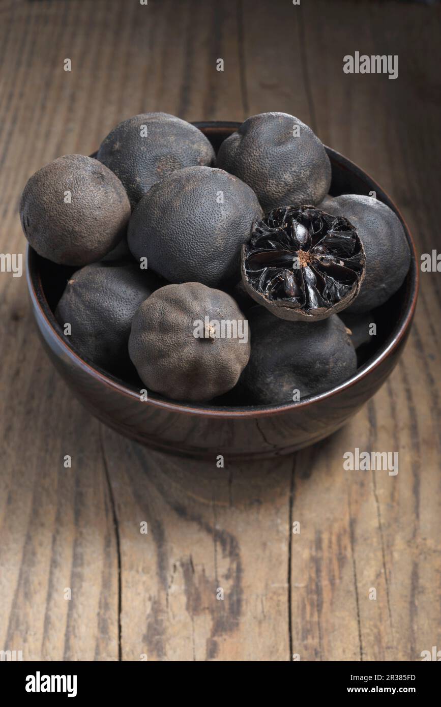 Loomi (dried limes, Middle East) in a small bowl Stock Photo - Alamy