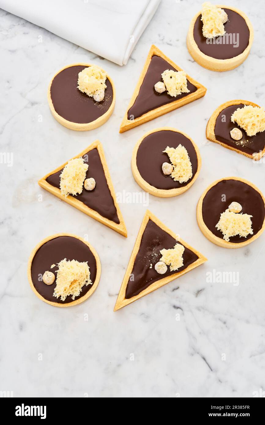 Circle and triangle shaped chocolate tarts Stock Photo - Alamy