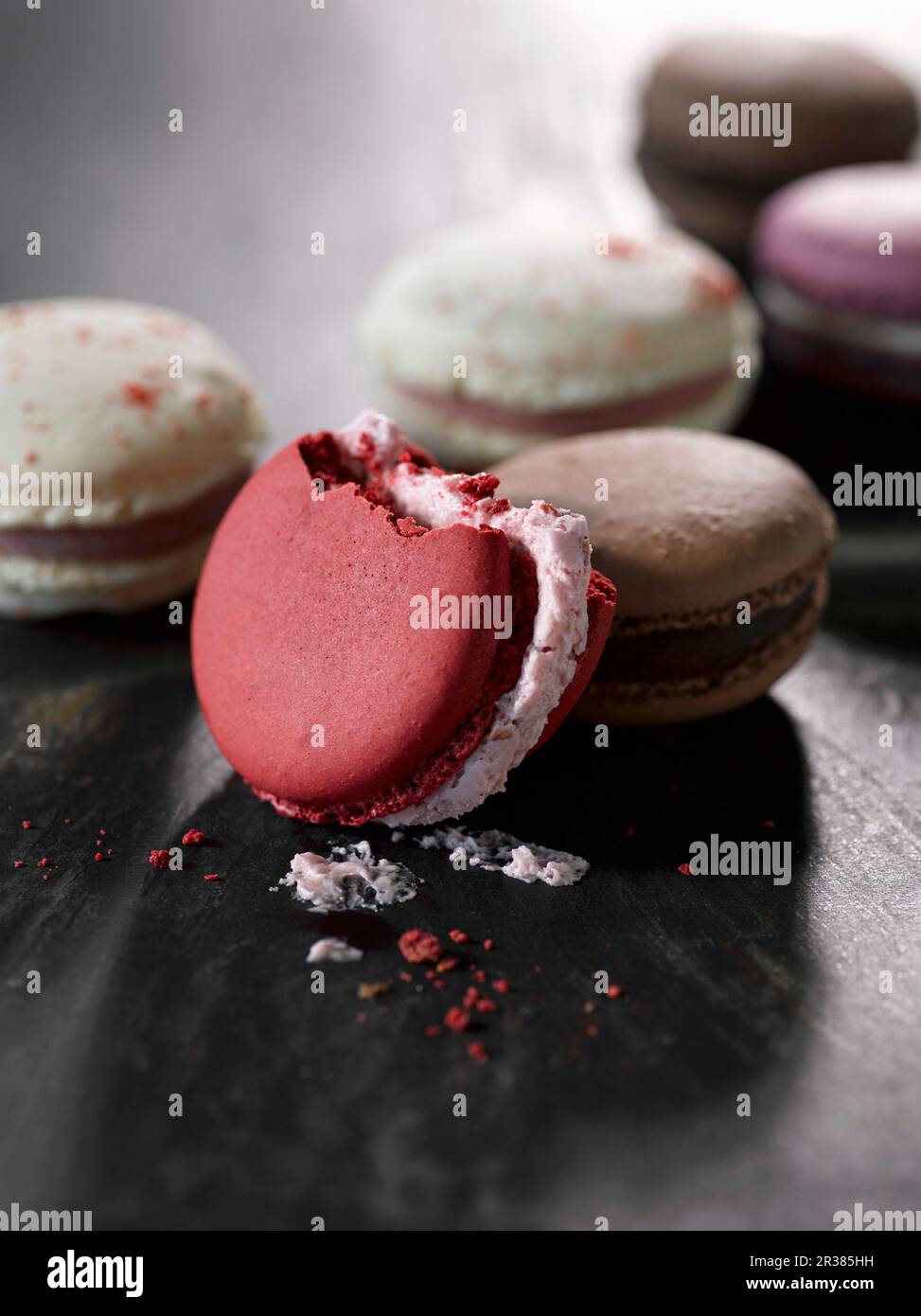 French macarons, with a bite taken out of one Stock Photo - Alamy