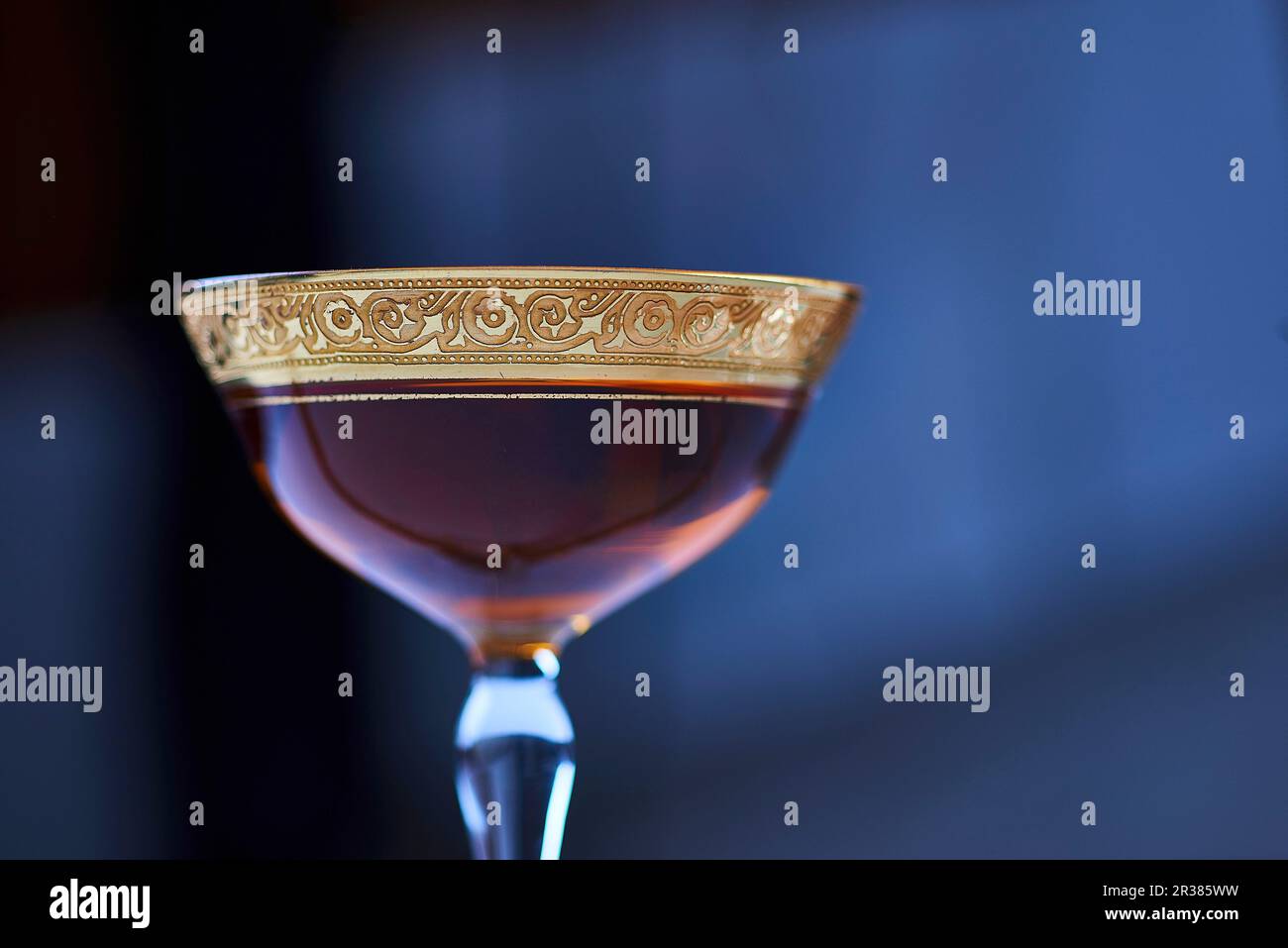 A Manhattan in an elegant gold-rimmed glass Stock Photo - Alamy
