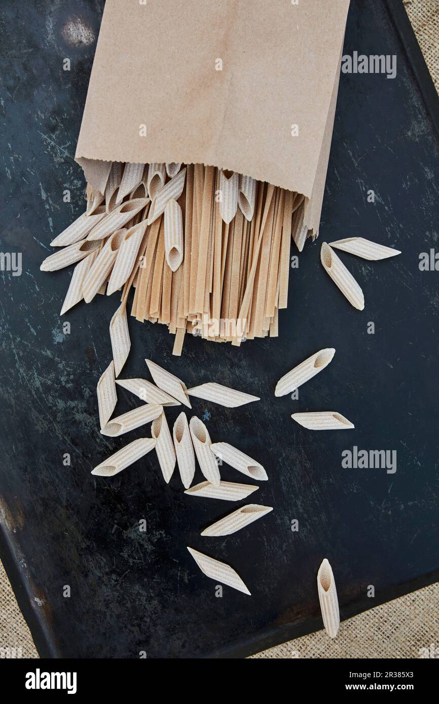 Various types of wholemeal pasta in a paper bag Stock Photo - Alamy