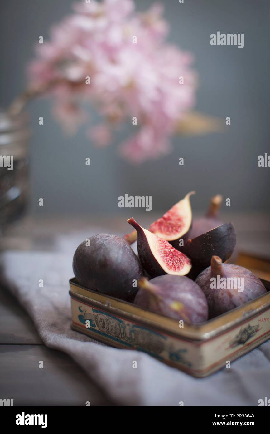 Vintage tin full of fresh figs topped with a quartered fruit Stock ...