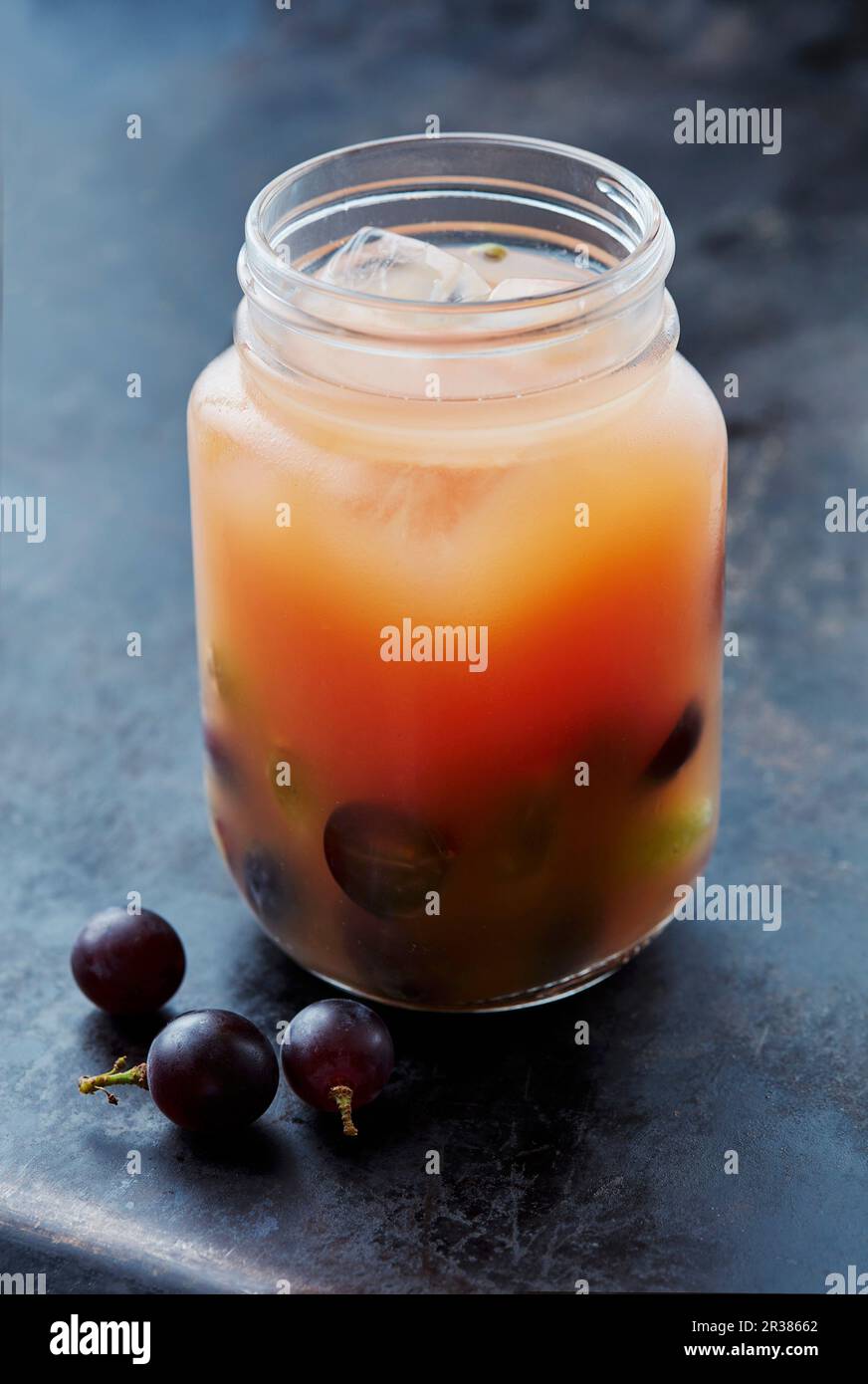 Water with grapes and ice cubes Stock Photo - Alamy