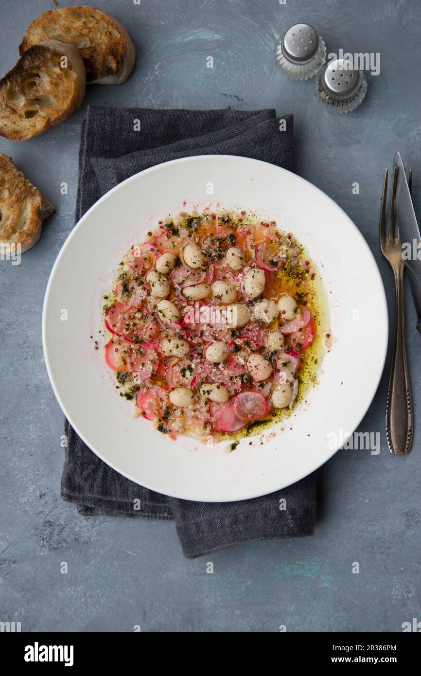 Radish salad with white beans, red quinoa, and kale powder Stock Photo ...