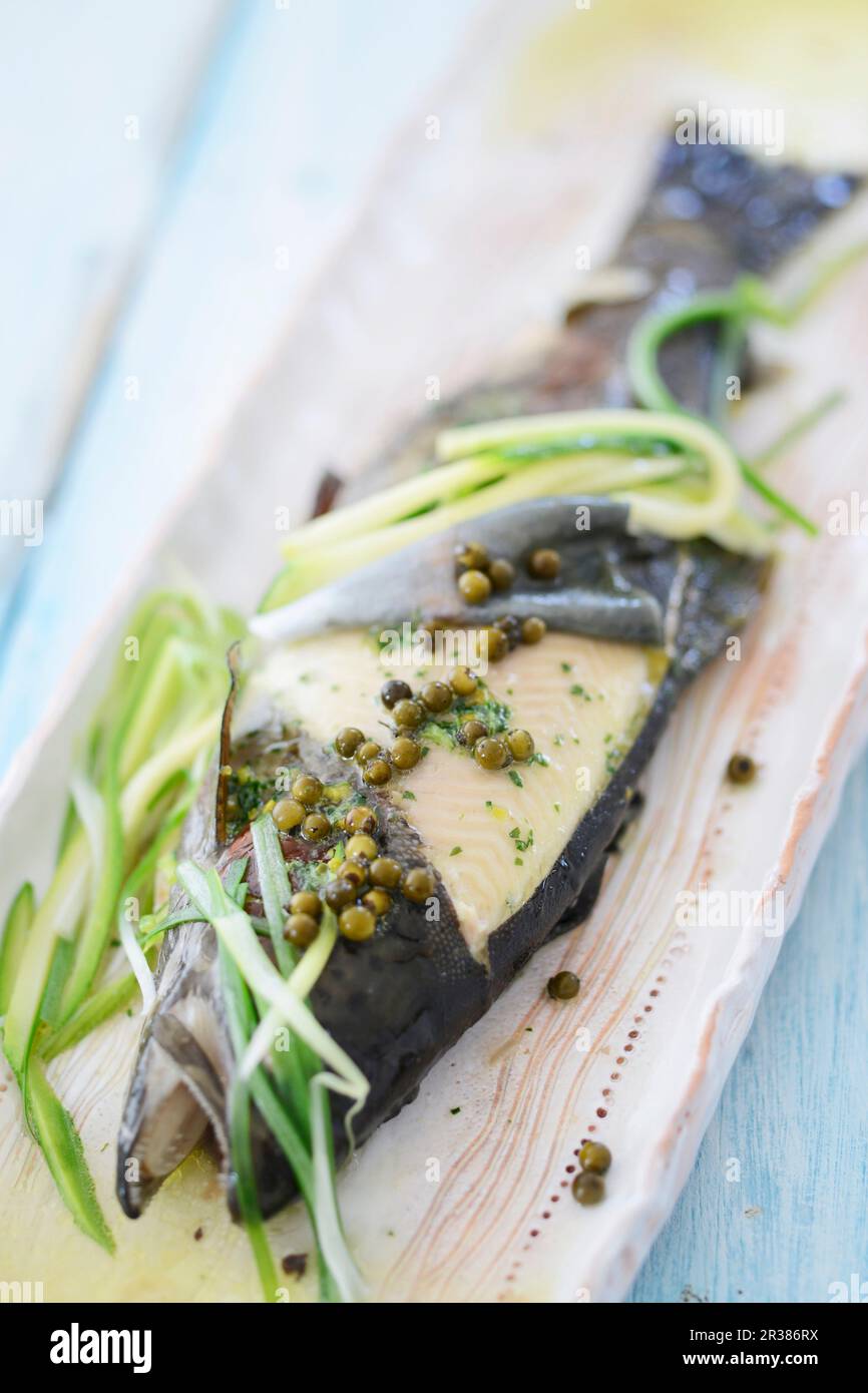 Poached trout with green pepper Stock Photo - Alamy