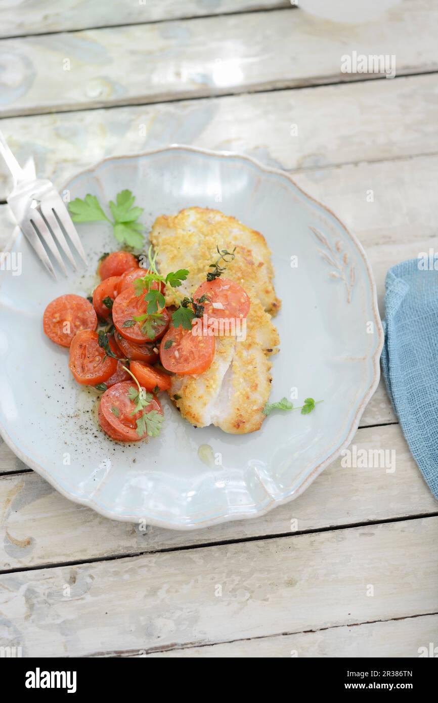 A fried redfish fillet with tomato salad Stock Photo - Alamy