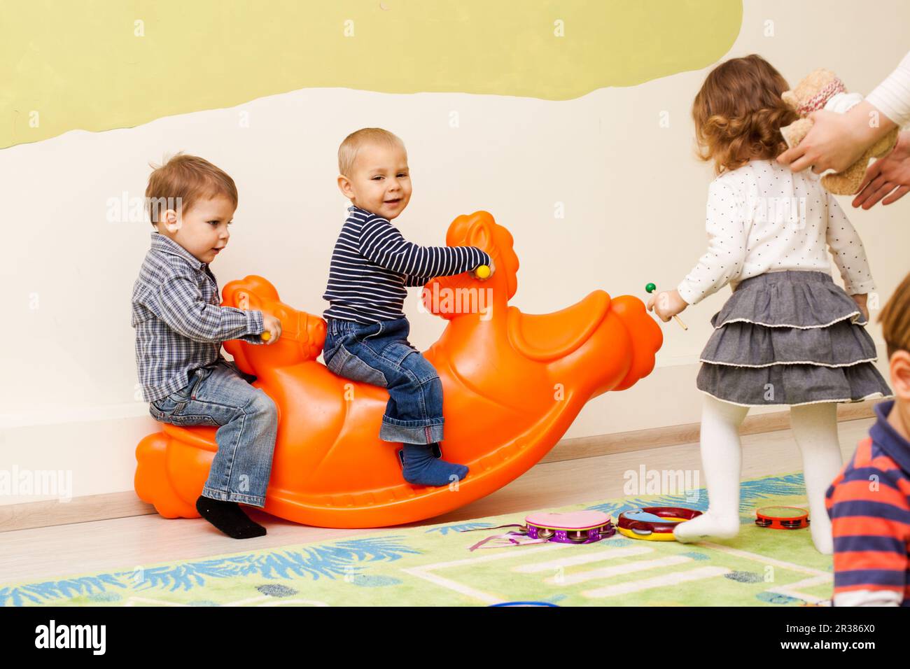 Children on the rocking seesaw Stock Photo - Alamy