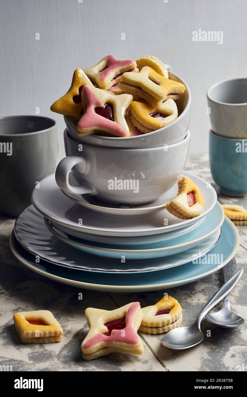Butter biscuits filled with jam and decorated with two tone icing Stock ...