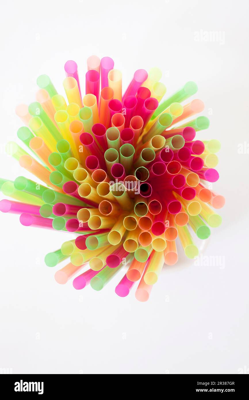 Colorful straws on a white background Stock Photo - Alamy