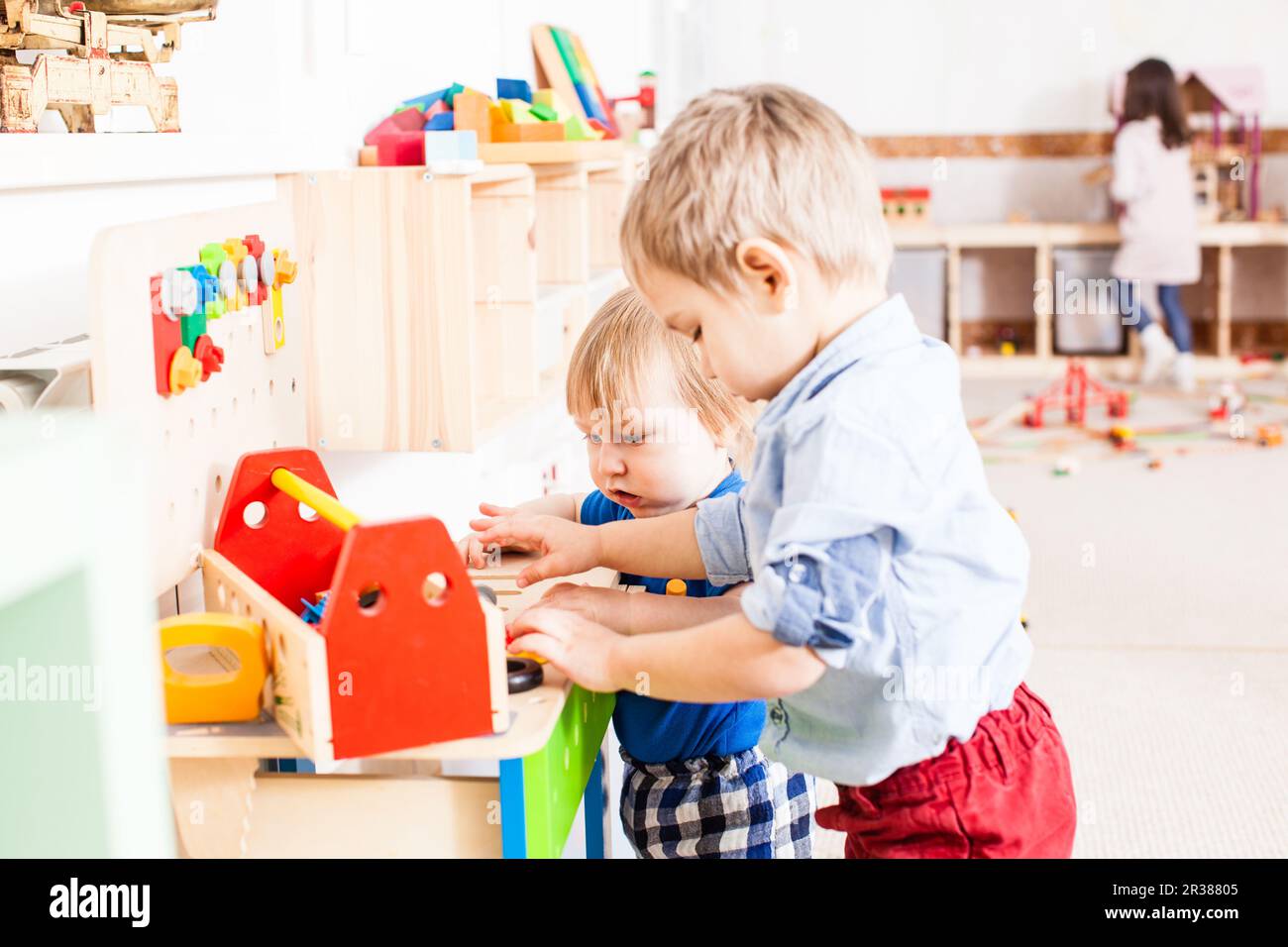 Boys play with wooden toys Stock Photo - Alamy
