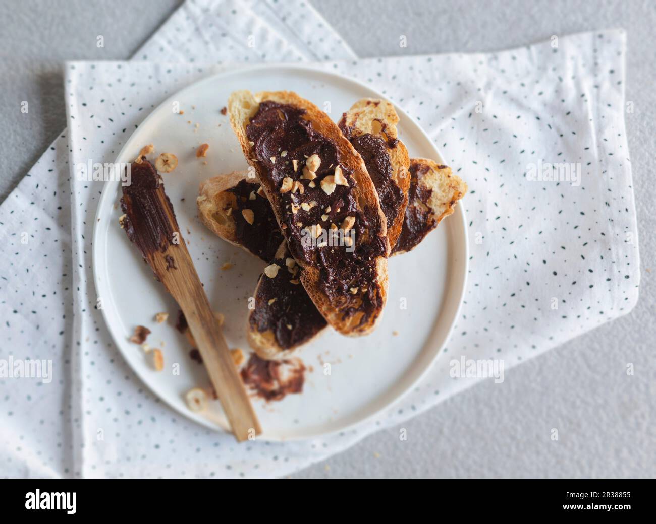 Toasted bread with nutella and chopped nuts Stock Photo - Alamy