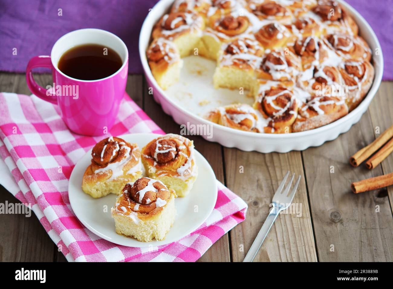 Cinnamon rolls served with tea Stock Photo - Alamy