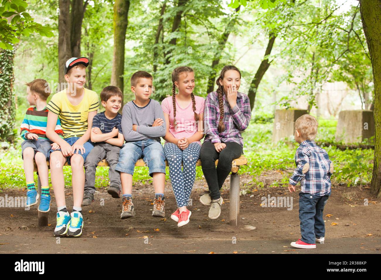 Kids on the bench Stock Photo - Alamy