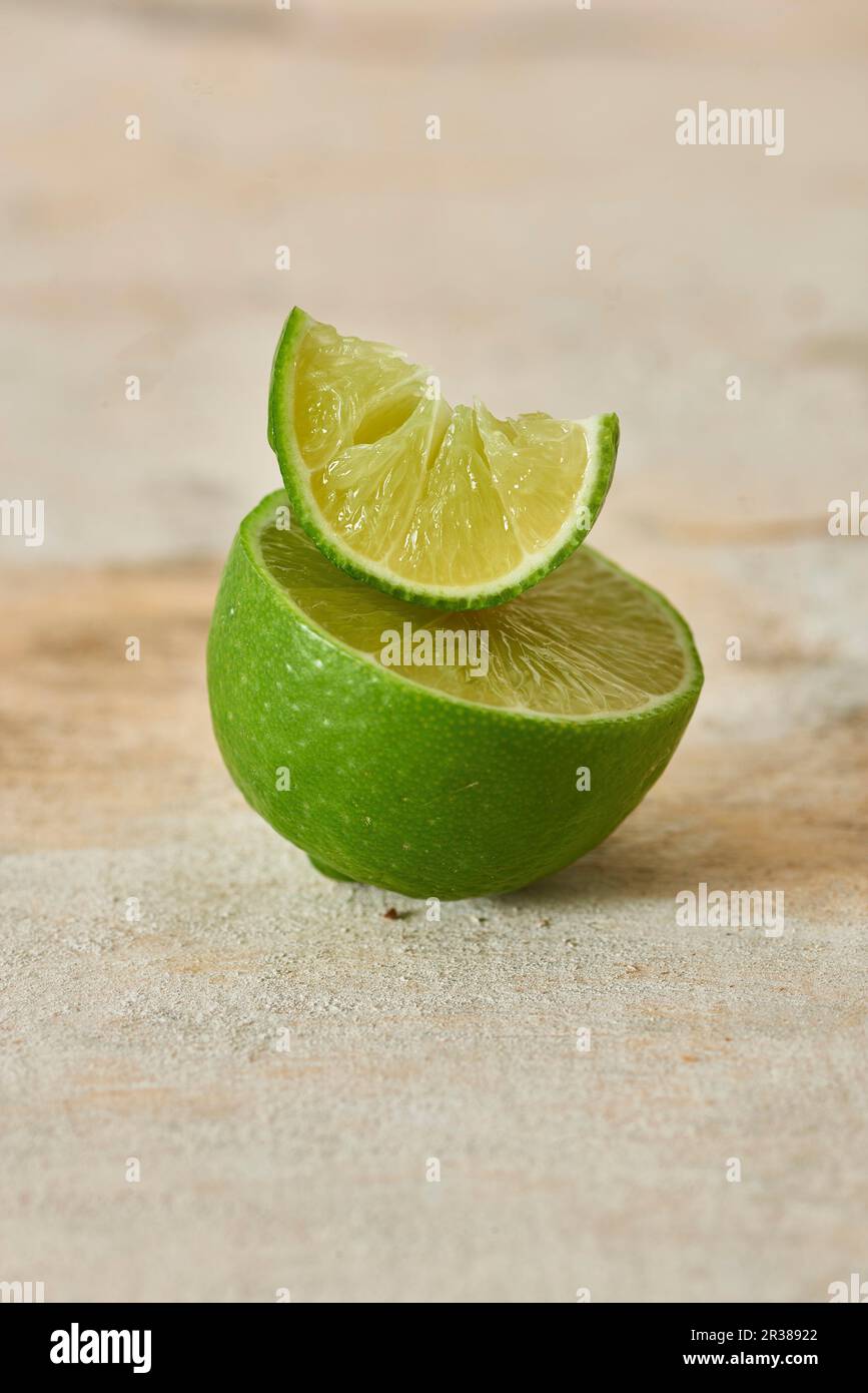 Half a lime and a small slice of lime Stock Photo - Alamy