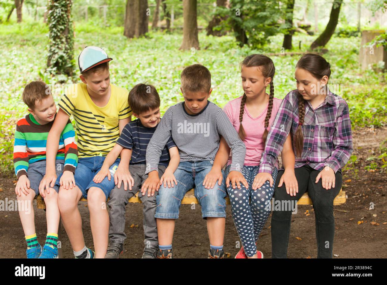 Kids on the bench Stock Photo - Alamy