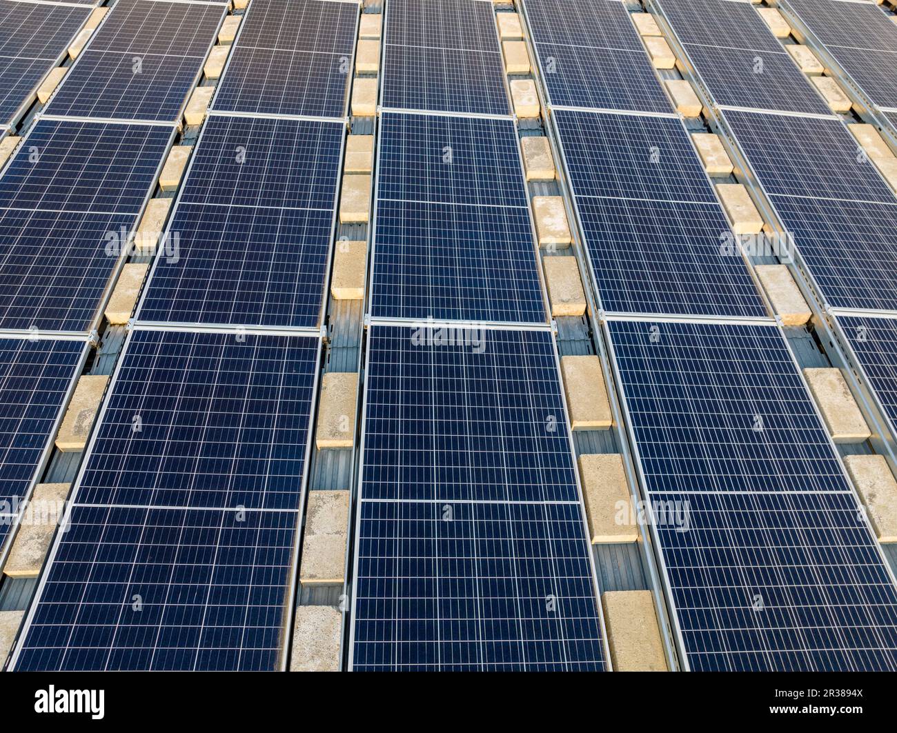 Aerial photo solar panels install on a flat commercial, industrial roof ...