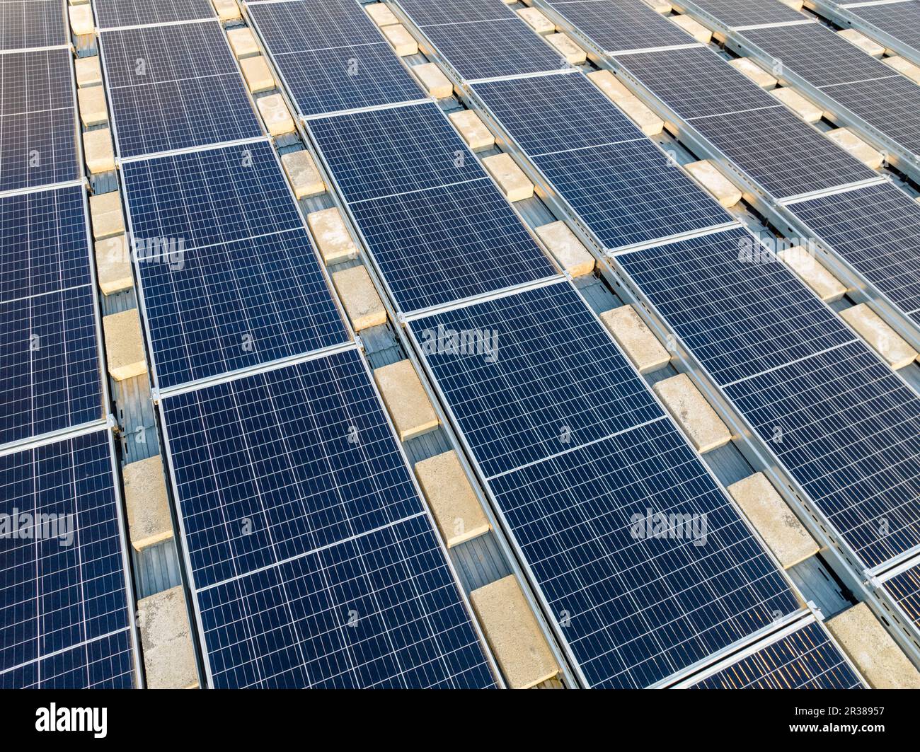 Aerial photo solar panels install on a flat commercial, industrial roof ...