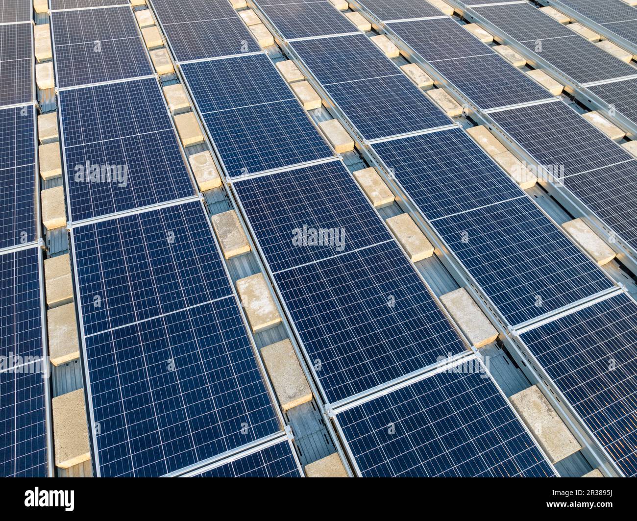 Aerial photo solar panels install on a flat commercial, industrial roof ...