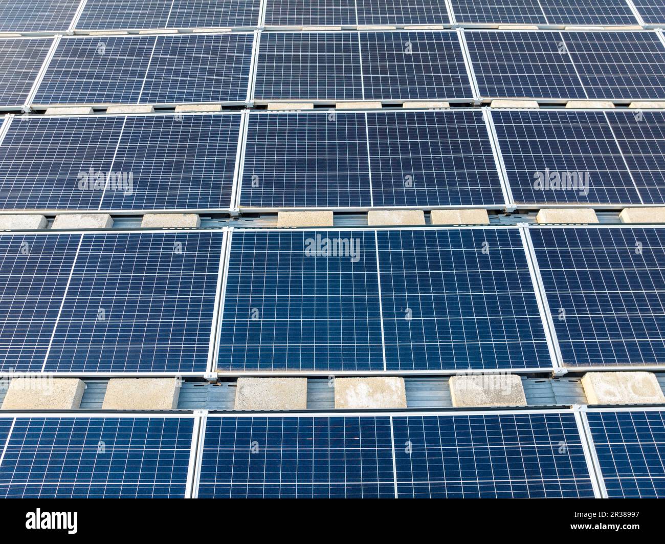 Aerial photo solar panels install on a flat commercial, industrial roof ...